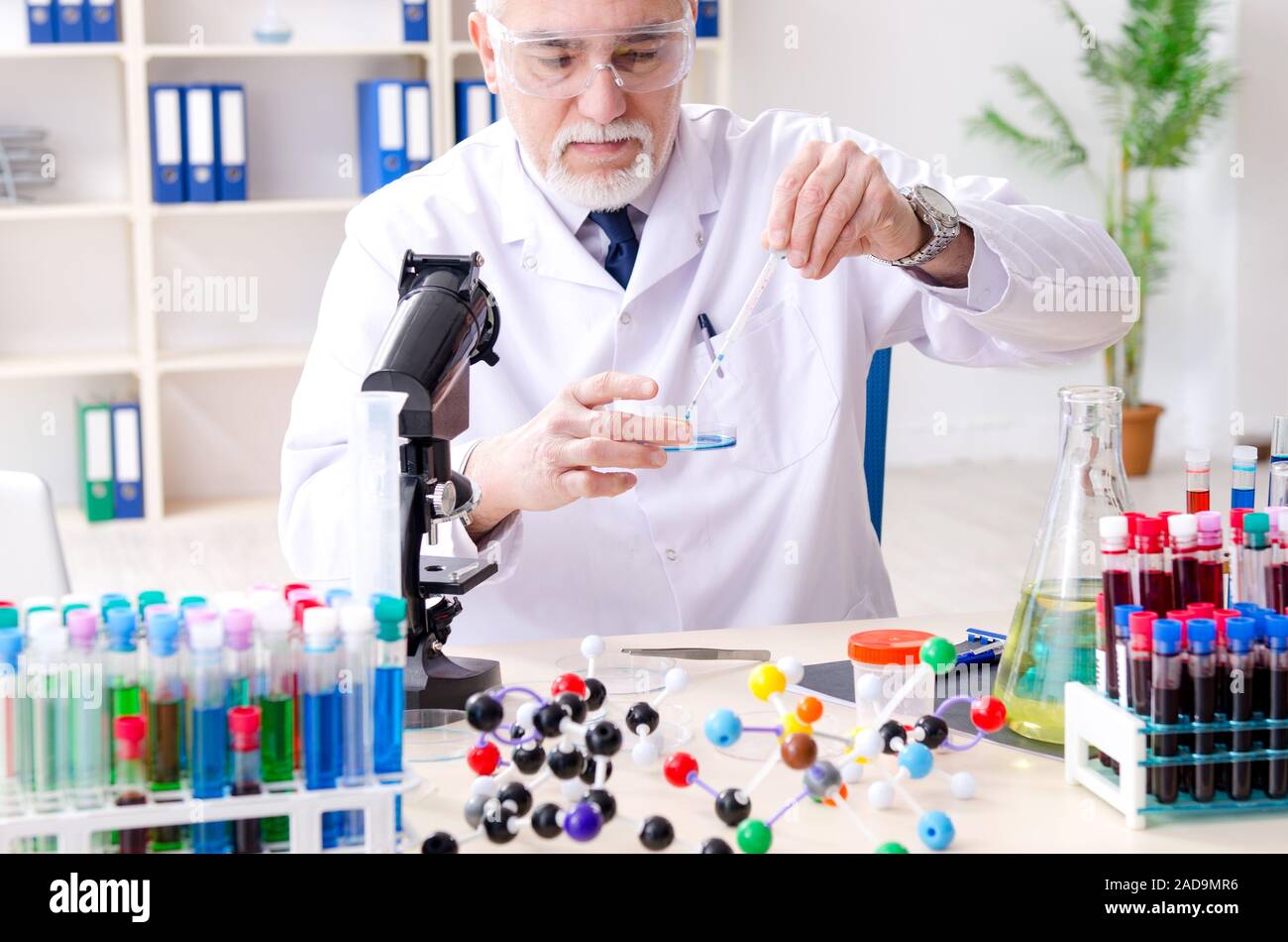Chemist examining test tubes taking hi-res stock photography and images ...