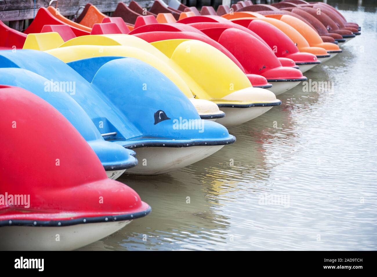 Colourful boats in shape of dolphins Stock Photo - Alamy