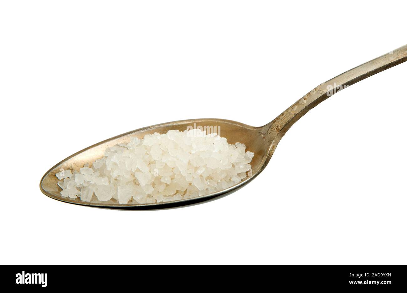 Coarse salt in a spoon isolated on a white background. View from above ...