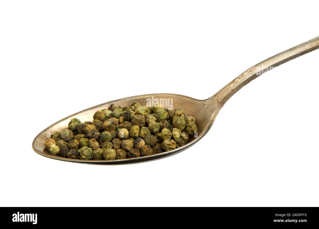 Green pepper in a spoon on isolate. View from above. Seasoning with ...