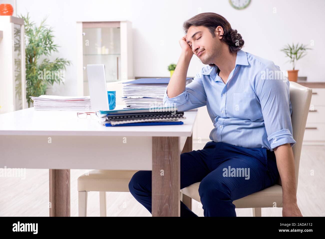 Young male employee working at home Stock Photo - Alamy