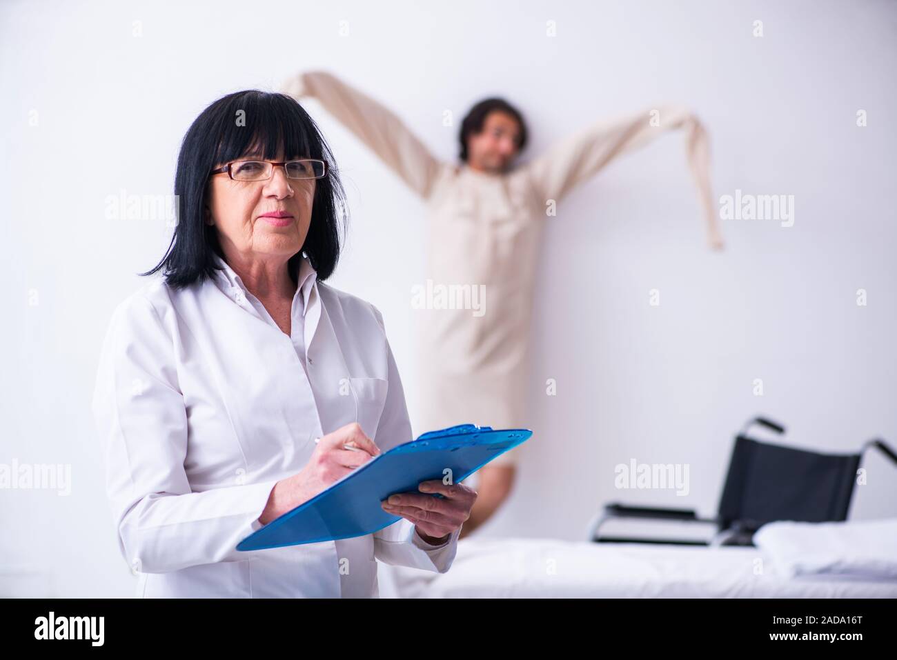 Old female psychiatrist visiting young male patient Stock Photo - Alamy