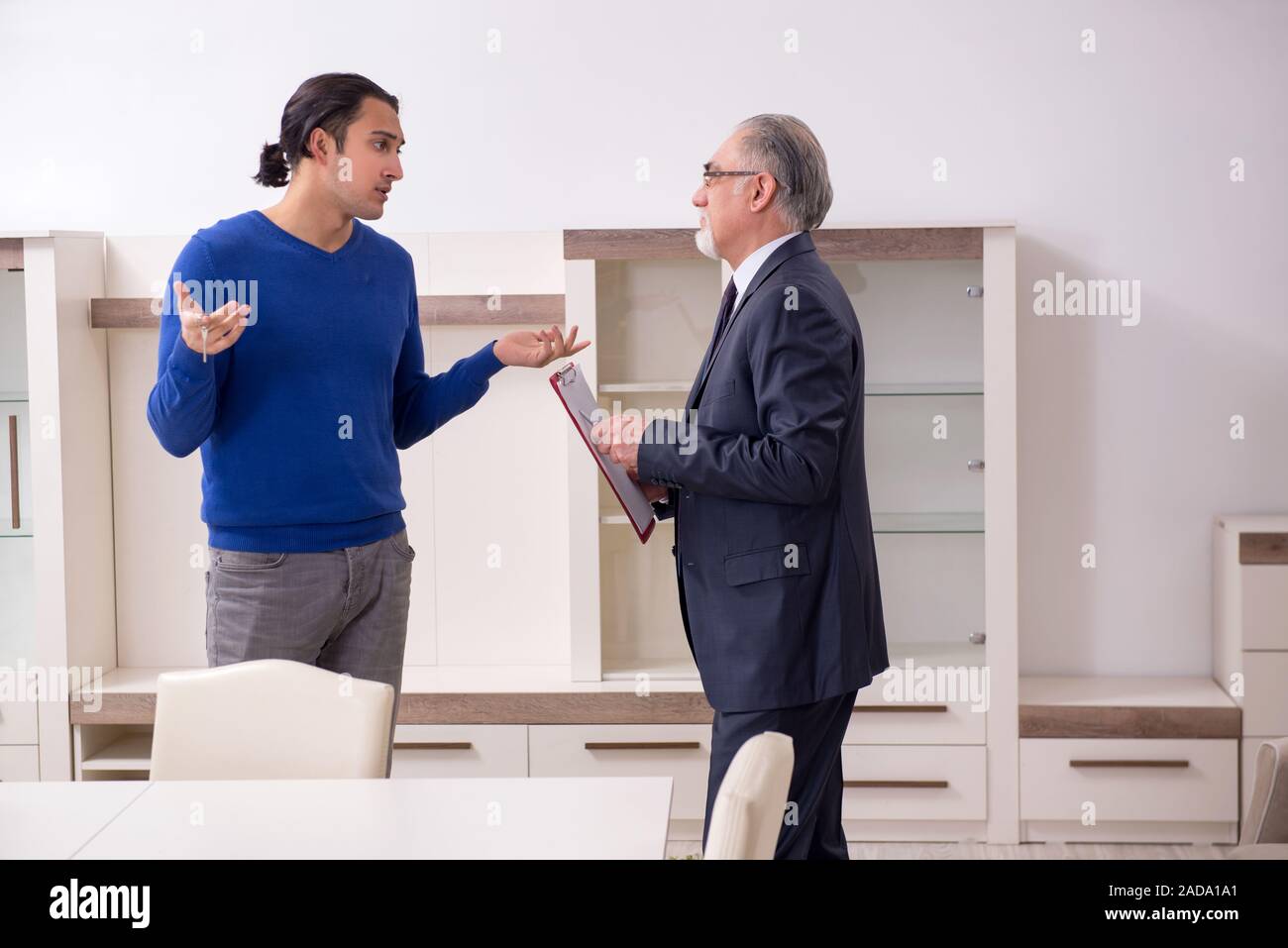 Male real estate agent and male client in the apartment Stock Photo - Alamy