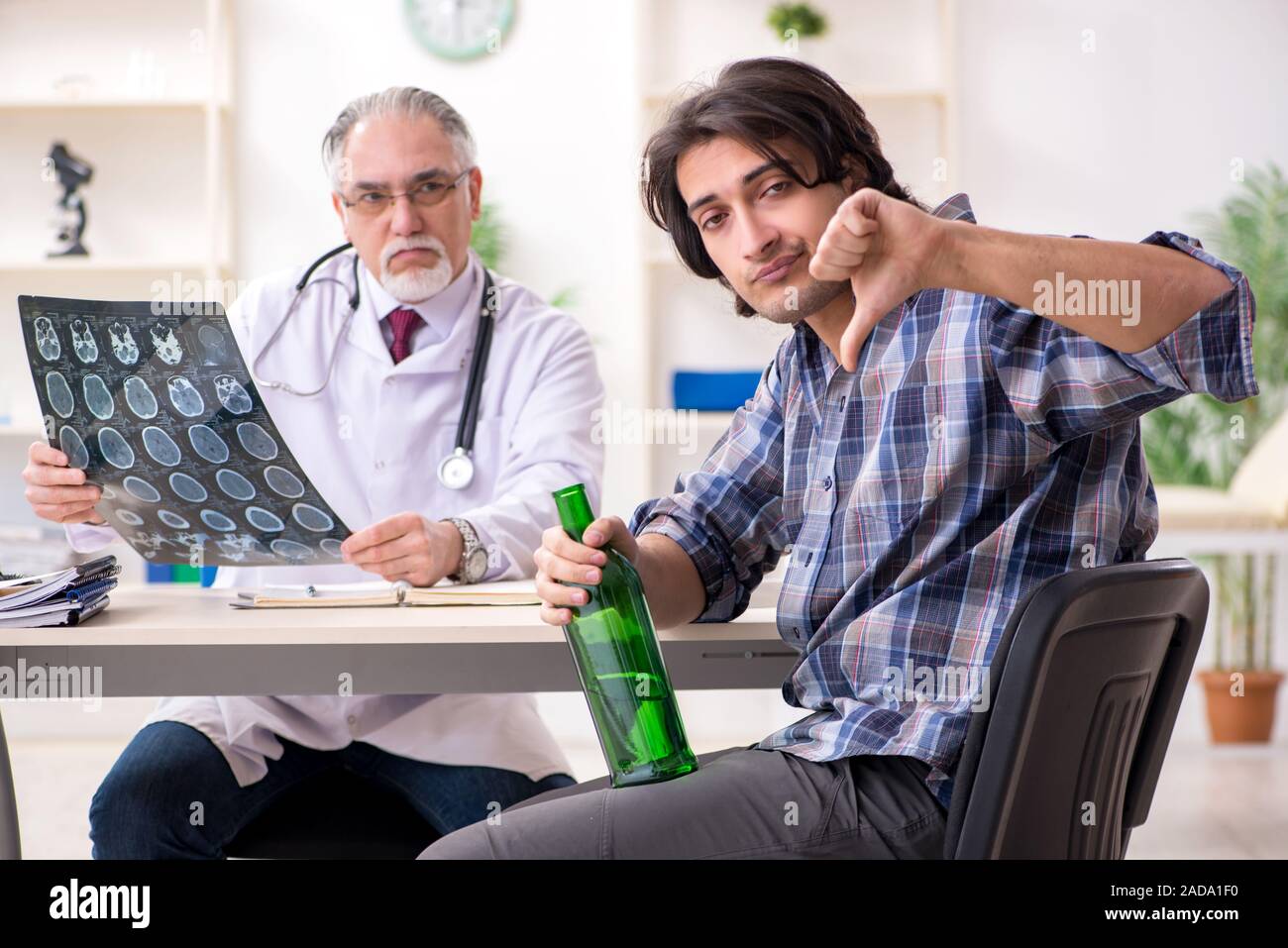 Young male alcoholic visiting old doctor Stock Photo - Alamy