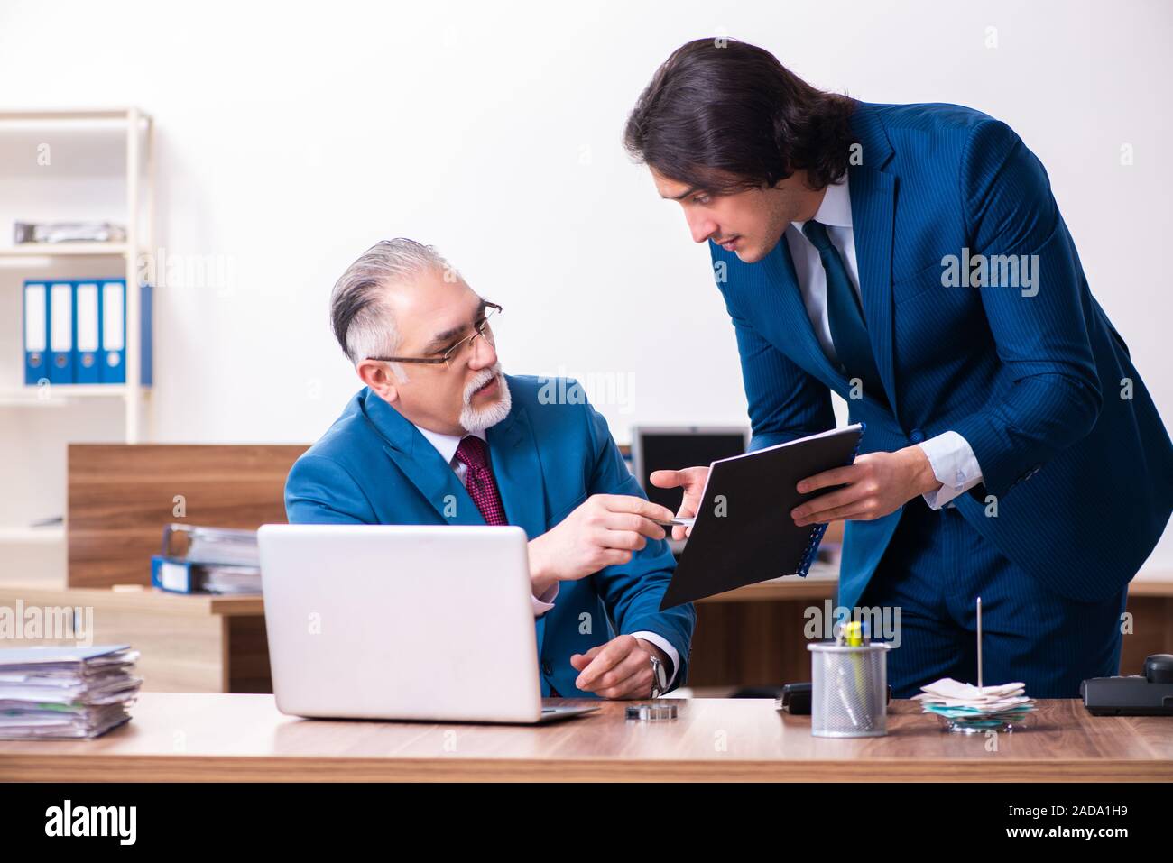 Young and old employees working together in the office Stock Photo - Alamy