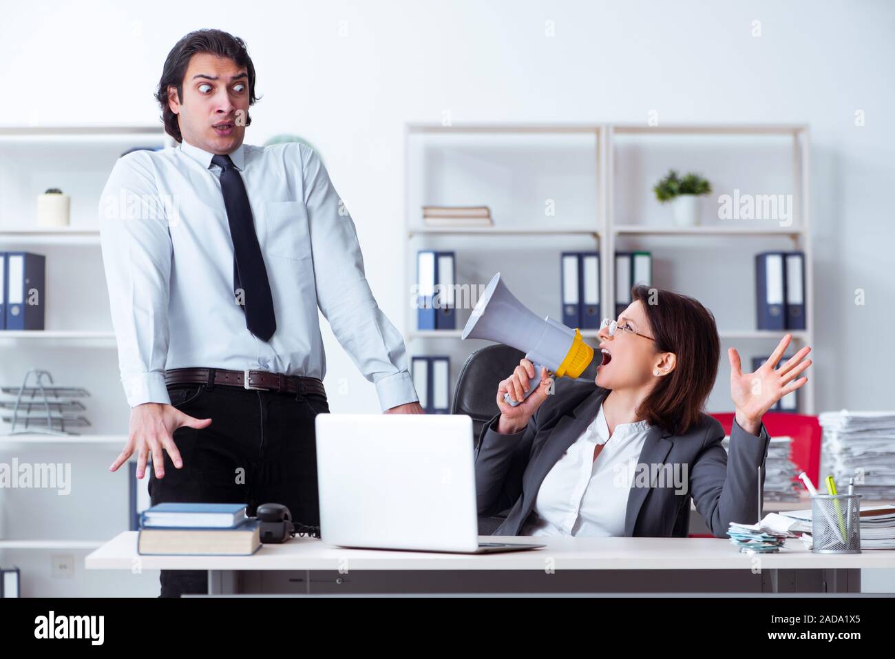 Old female boss and young male employee in the office Stock Photo - Alamy