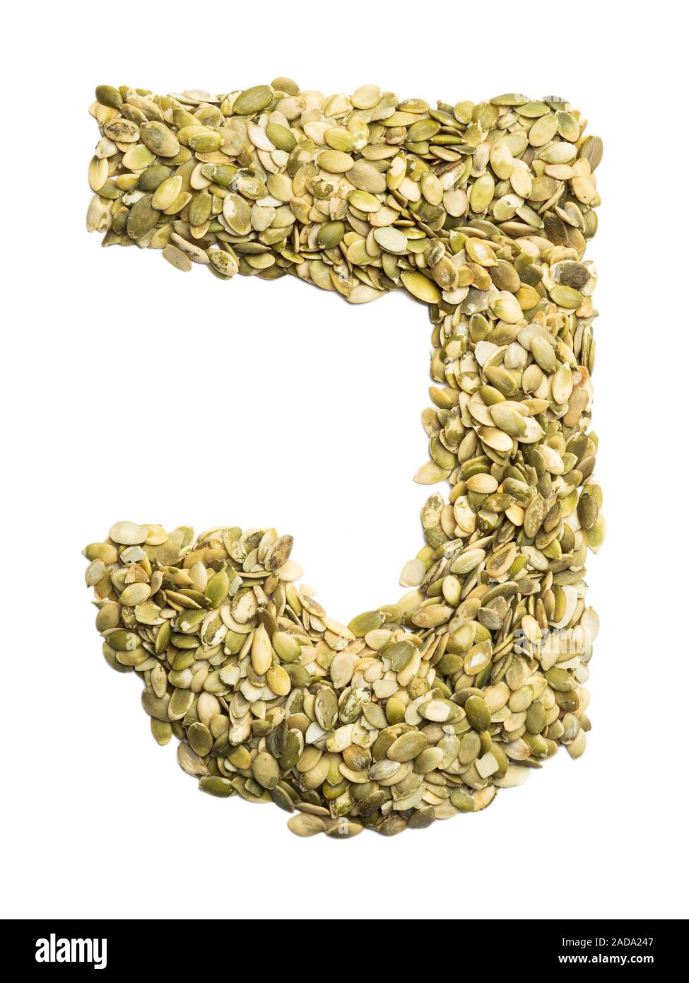 Letter J of the English alphabet from pumpkin seeds on a white isolated ...