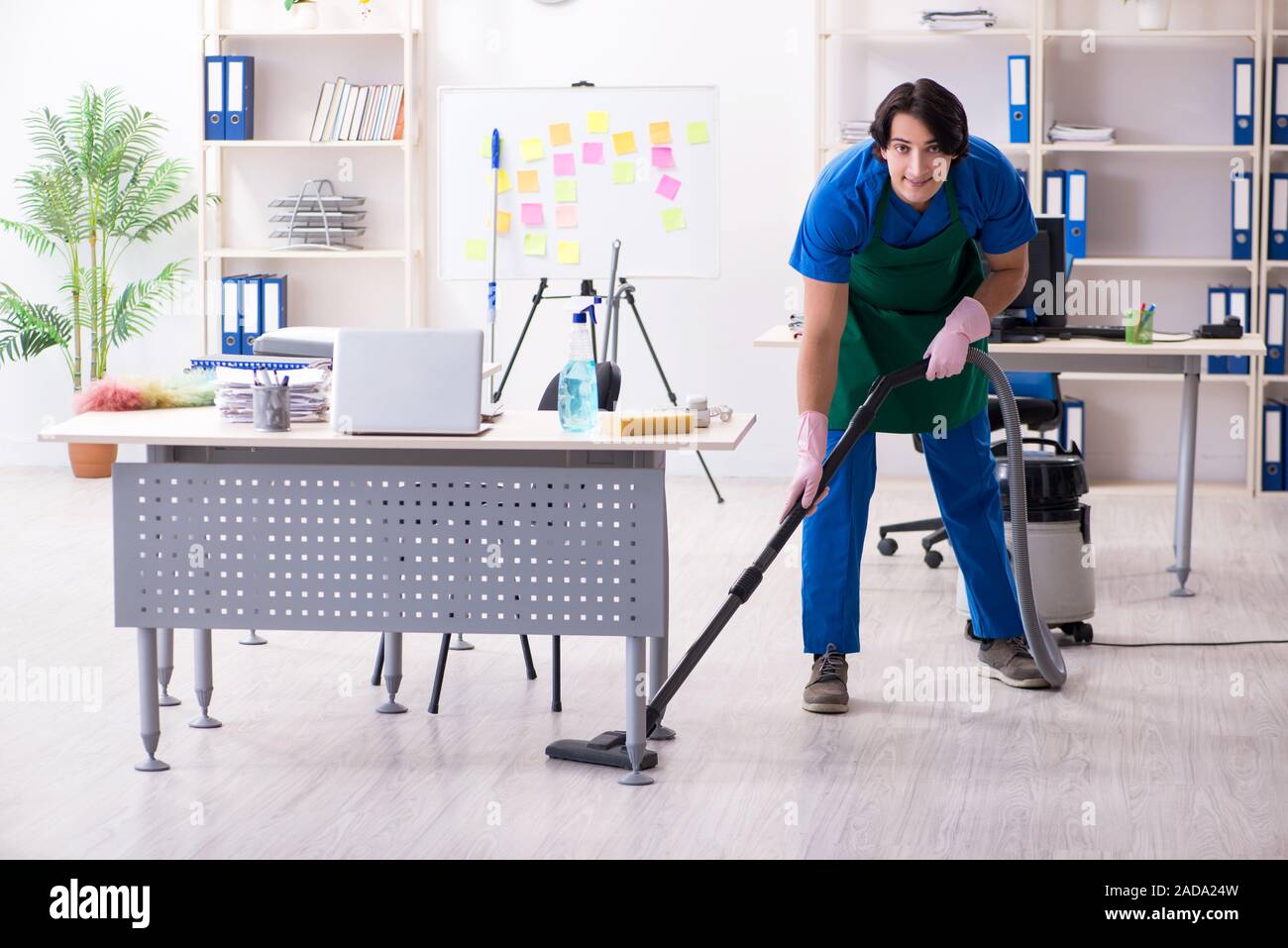 Office cleaner vacuuming hi-res stock photography and images - Alamy