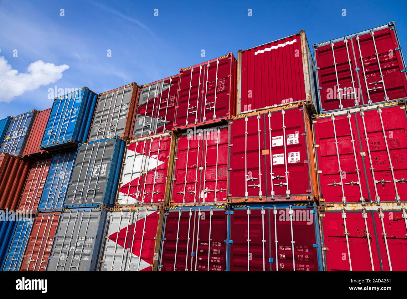The national flag of Bahrain on a large number of metal containers for ...