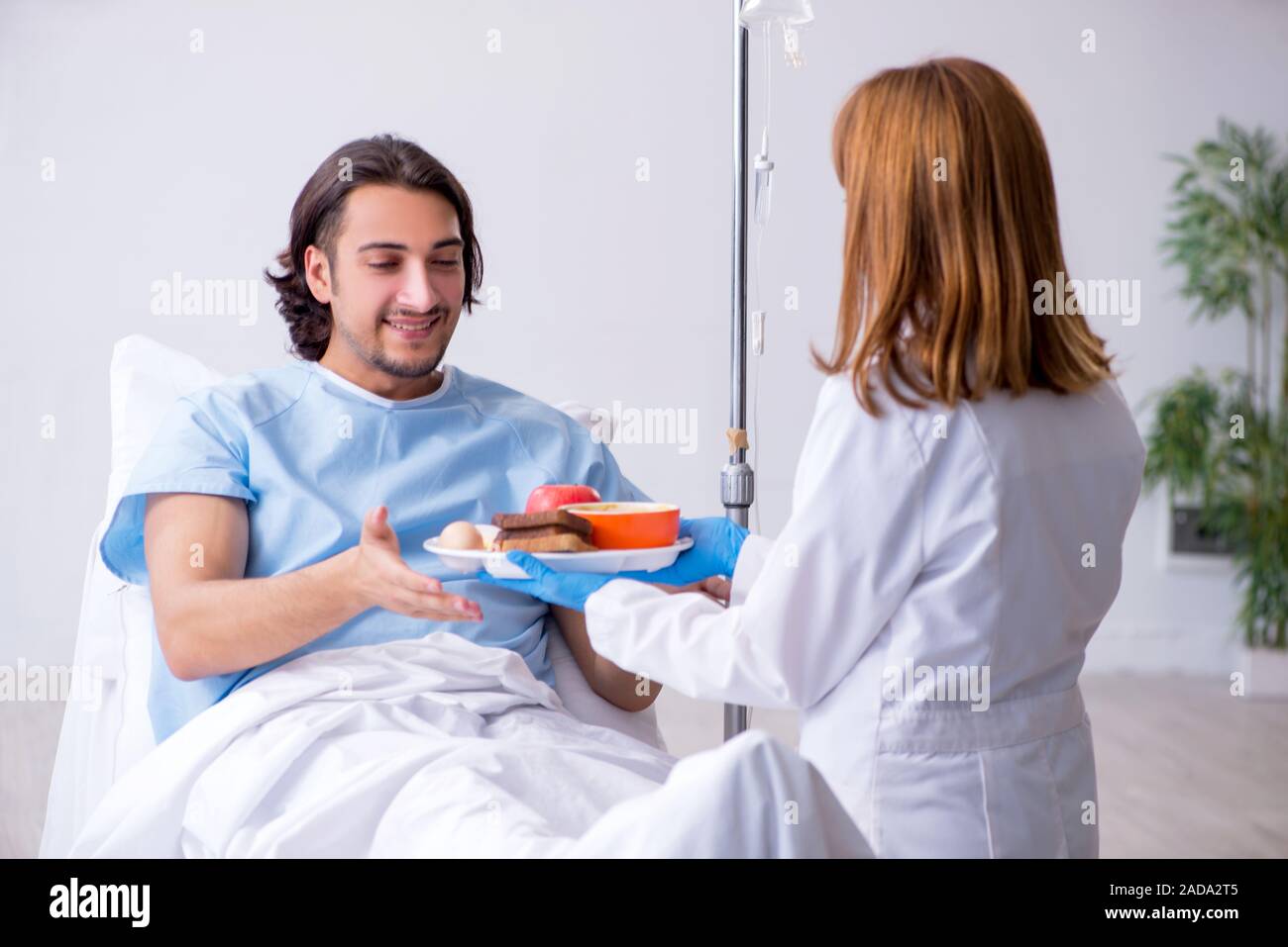Male patient eating food in the hospital Stock Photo - Alamy