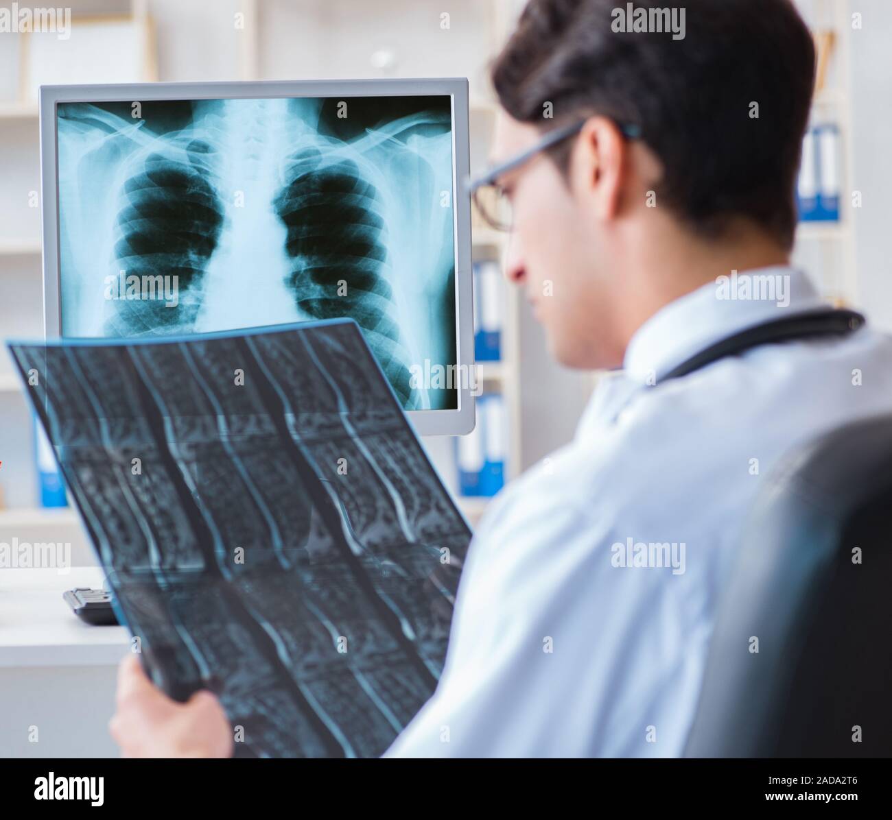 Doctor radiologist looking at x-ray images Stock Photo - Alamy