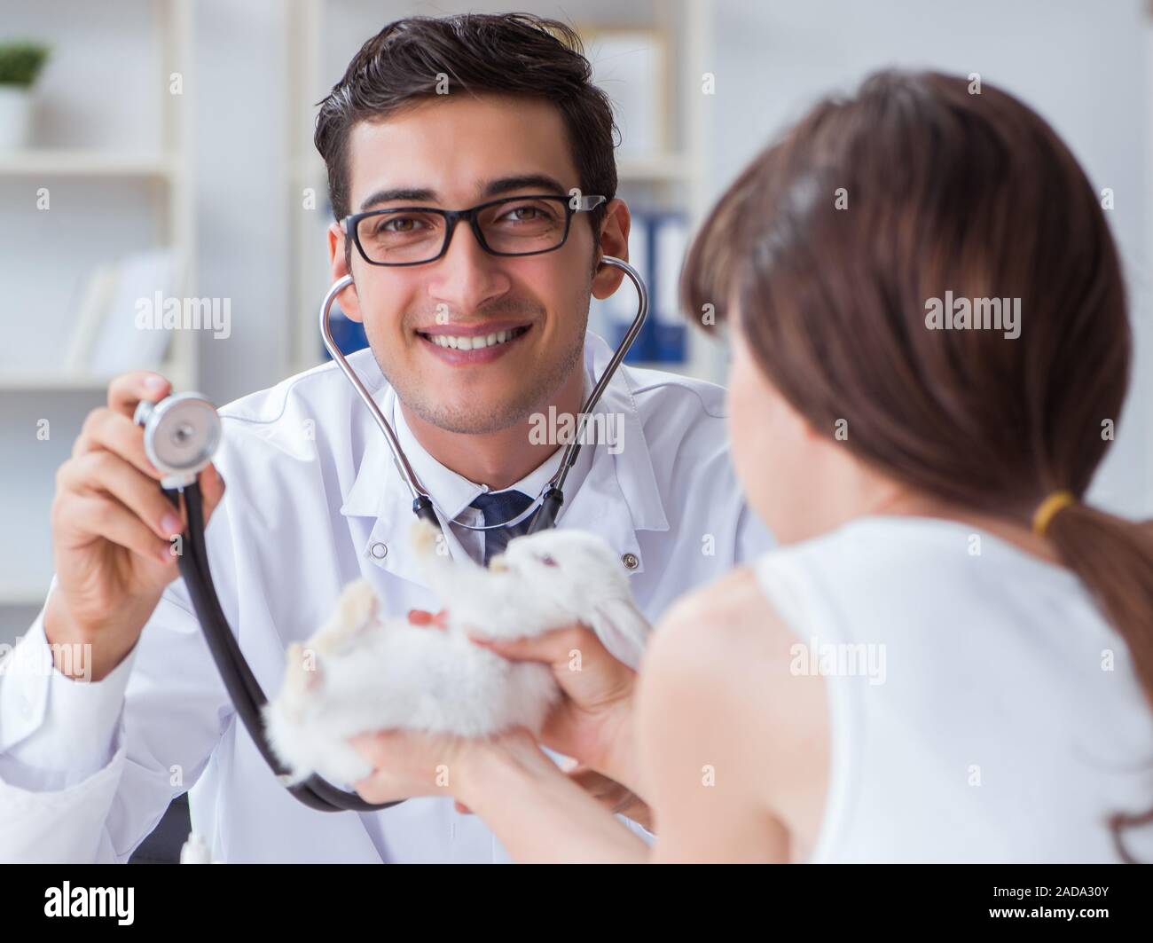 Woman with pet rabbit visiting vet doctor Stock Photo - Alamy