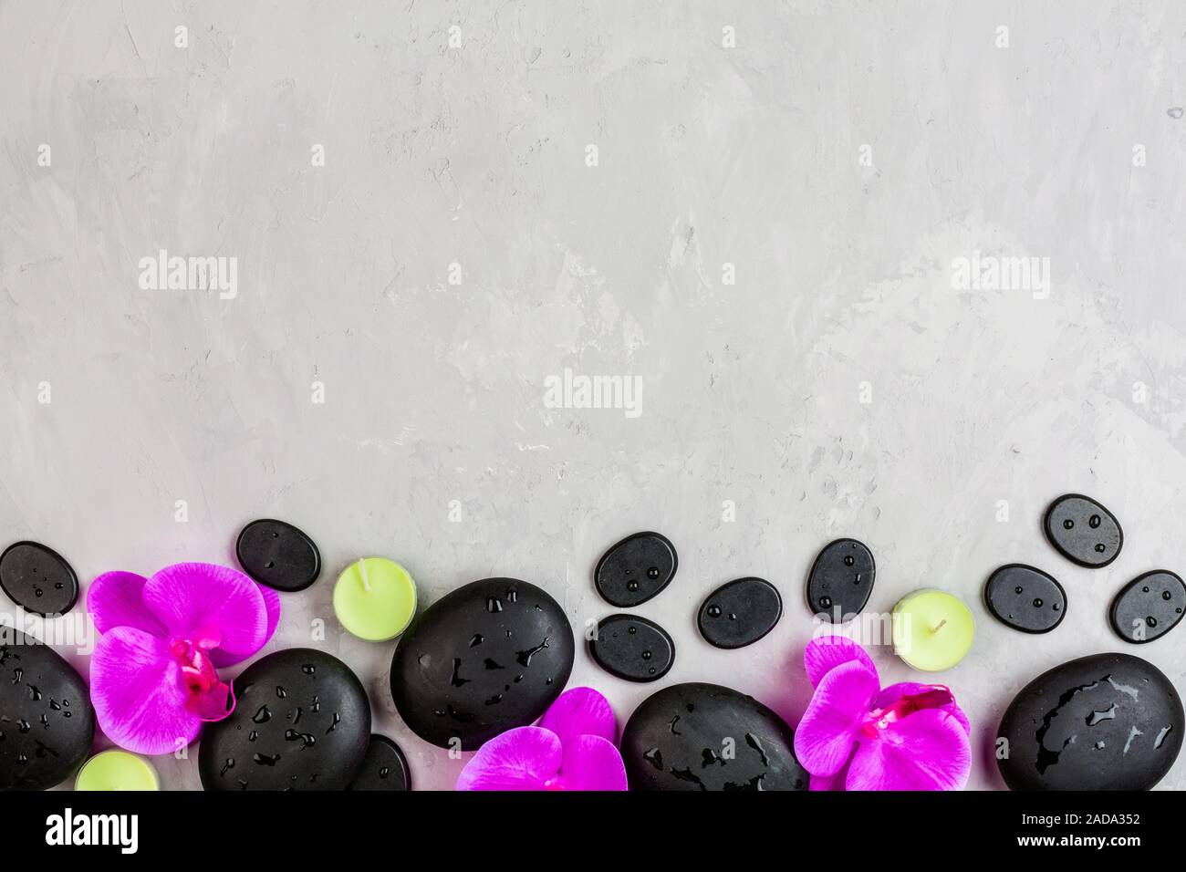 Top view of hot spa stones set for massage treatment and bamboo on ...