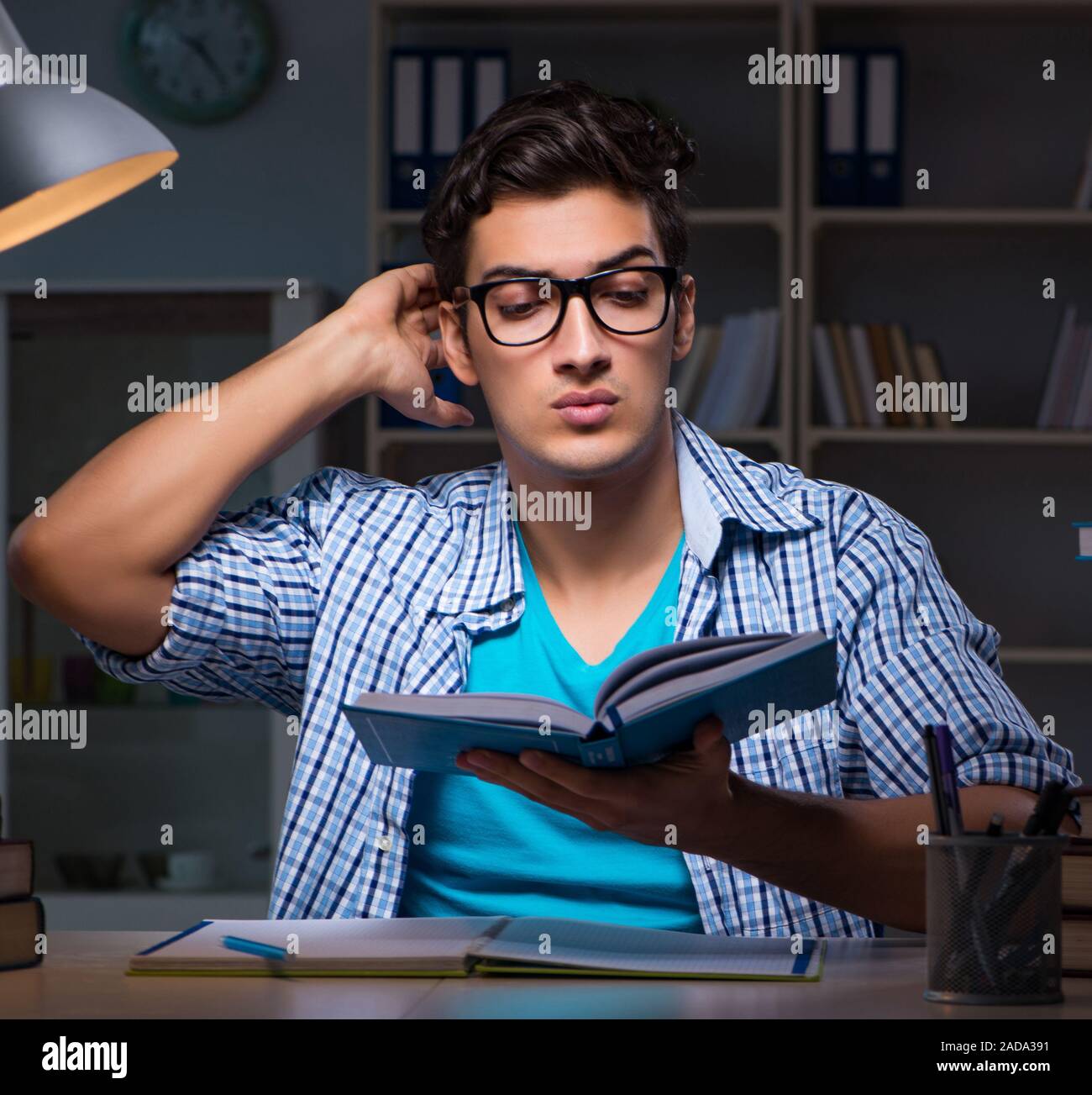 Student preparing for exams late night at home Stock Photo - Alamy