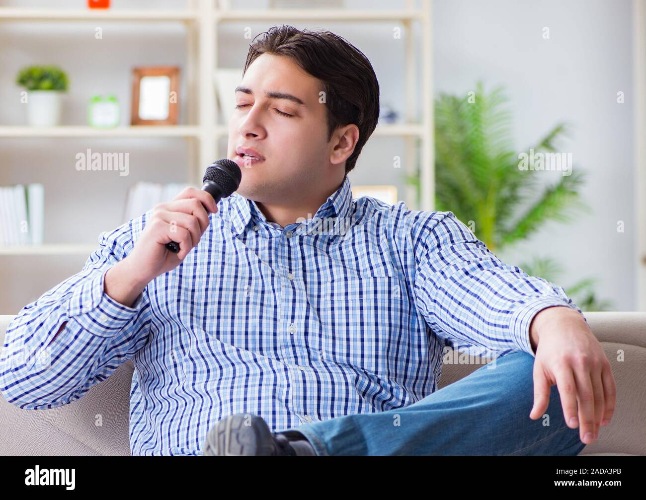 Funny man singing songs in karaoke at home Stock Photo - Alamy