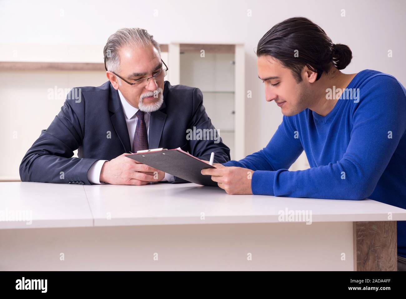 Male real estate agent and male client in the apartment Stock Photo - Alamy