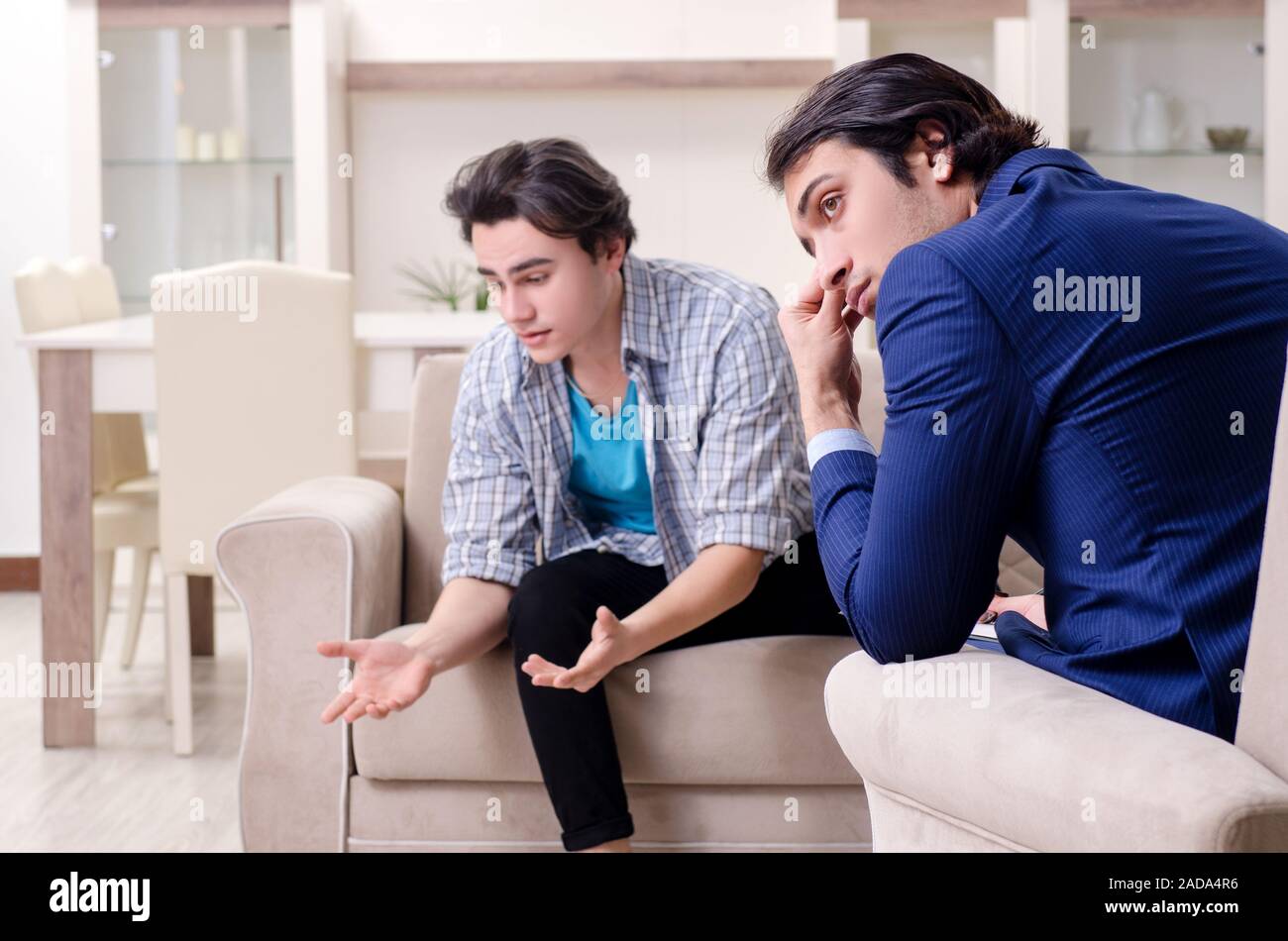 Young male patient discussing with psychologist personal problem Stock ...