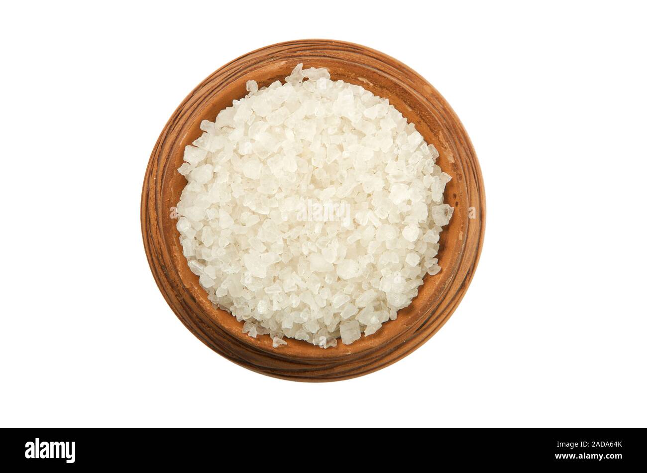 Salt in a clay cup isolated on a white background. View from above ...
