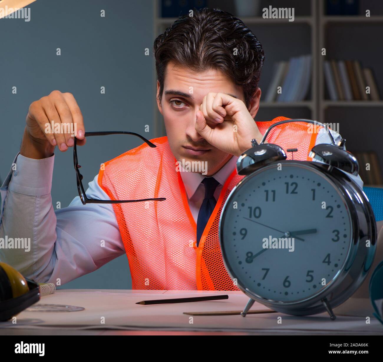 Tired architect working late long hours under stress to meet dea Stock ...