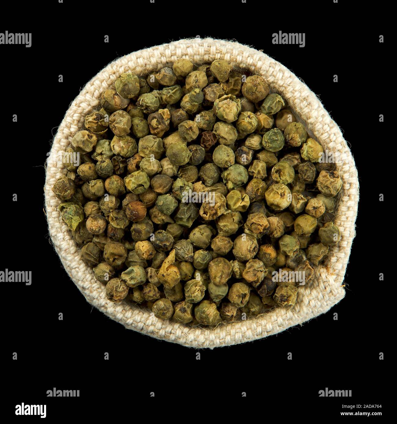Dry green pepper in a bag isolated on a black background. View from ...