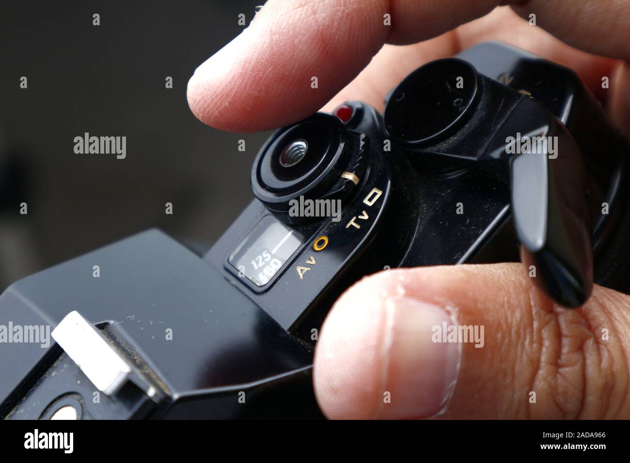 Fingers on the shutter button of an old and vintage 35mm film camera ...