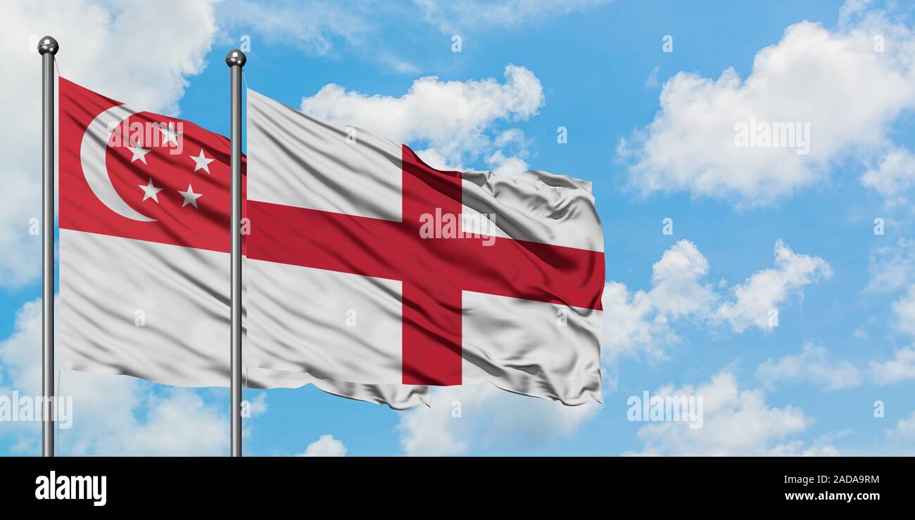 Singapore and England flag waving in the wind against white cloudy blue ...