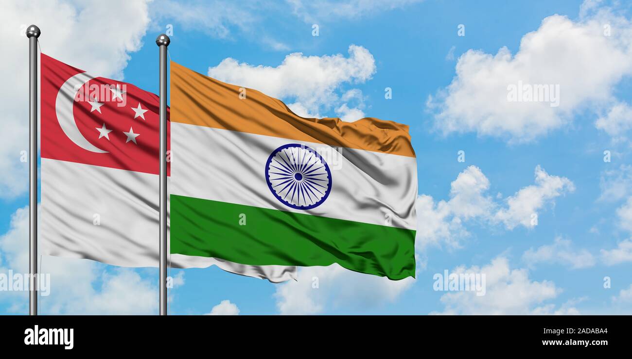 Singapore and India flag waving in the wind against white cloudy blue ...