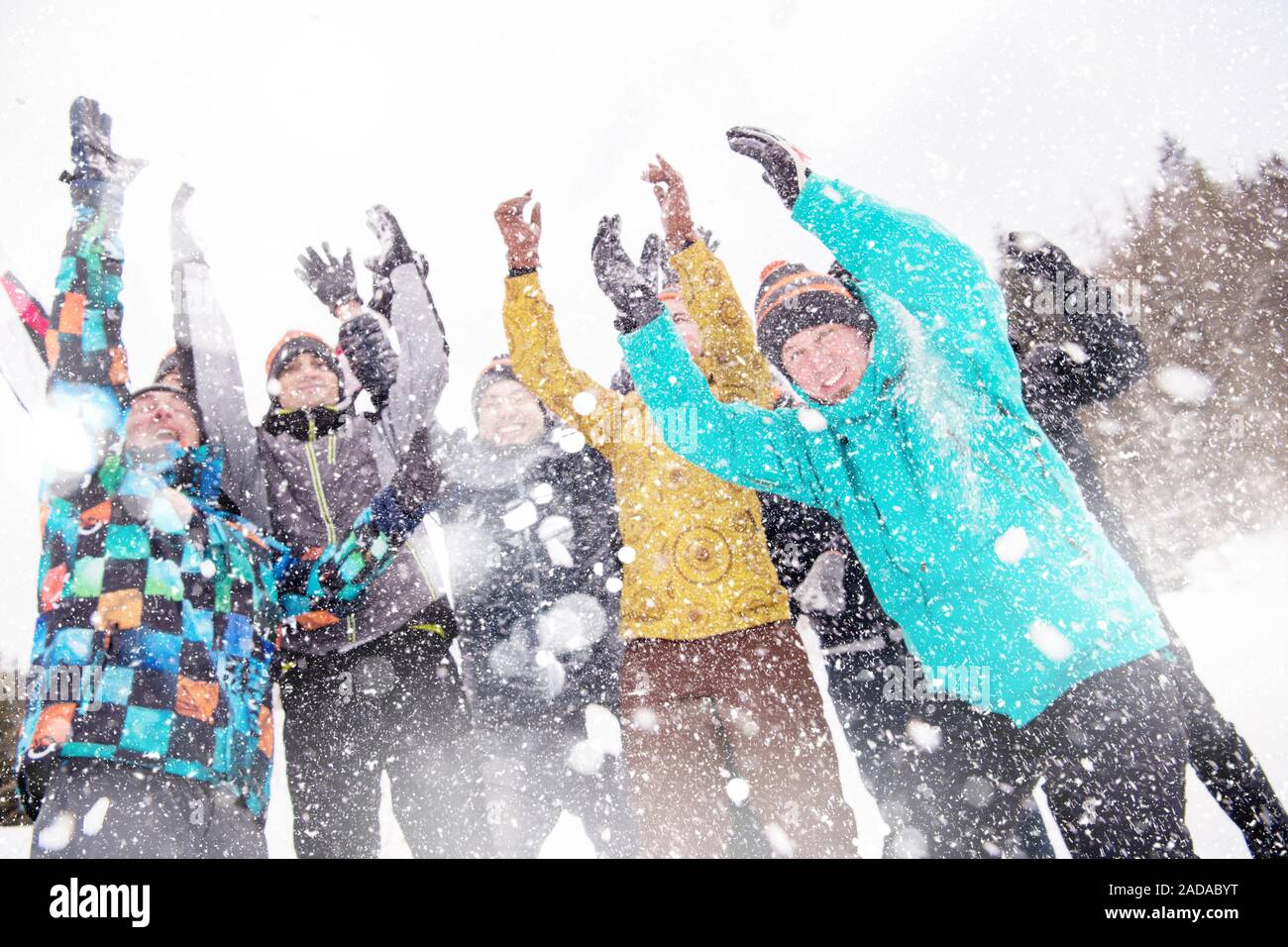 group of young people throwing snow in the air Stock Photo - Alamy