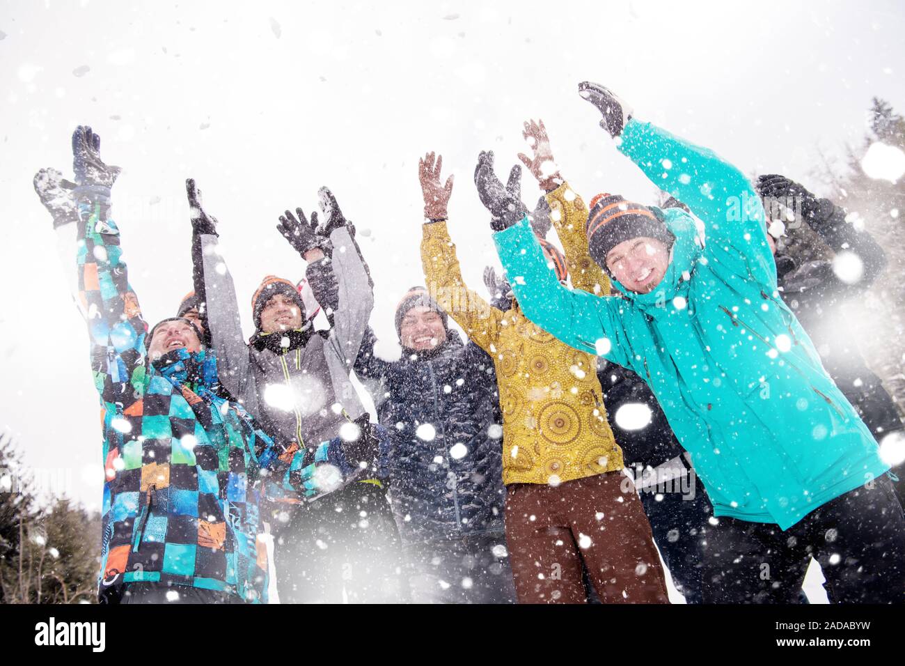 group of young people throwing snow in the air Stock Photo - Alamy