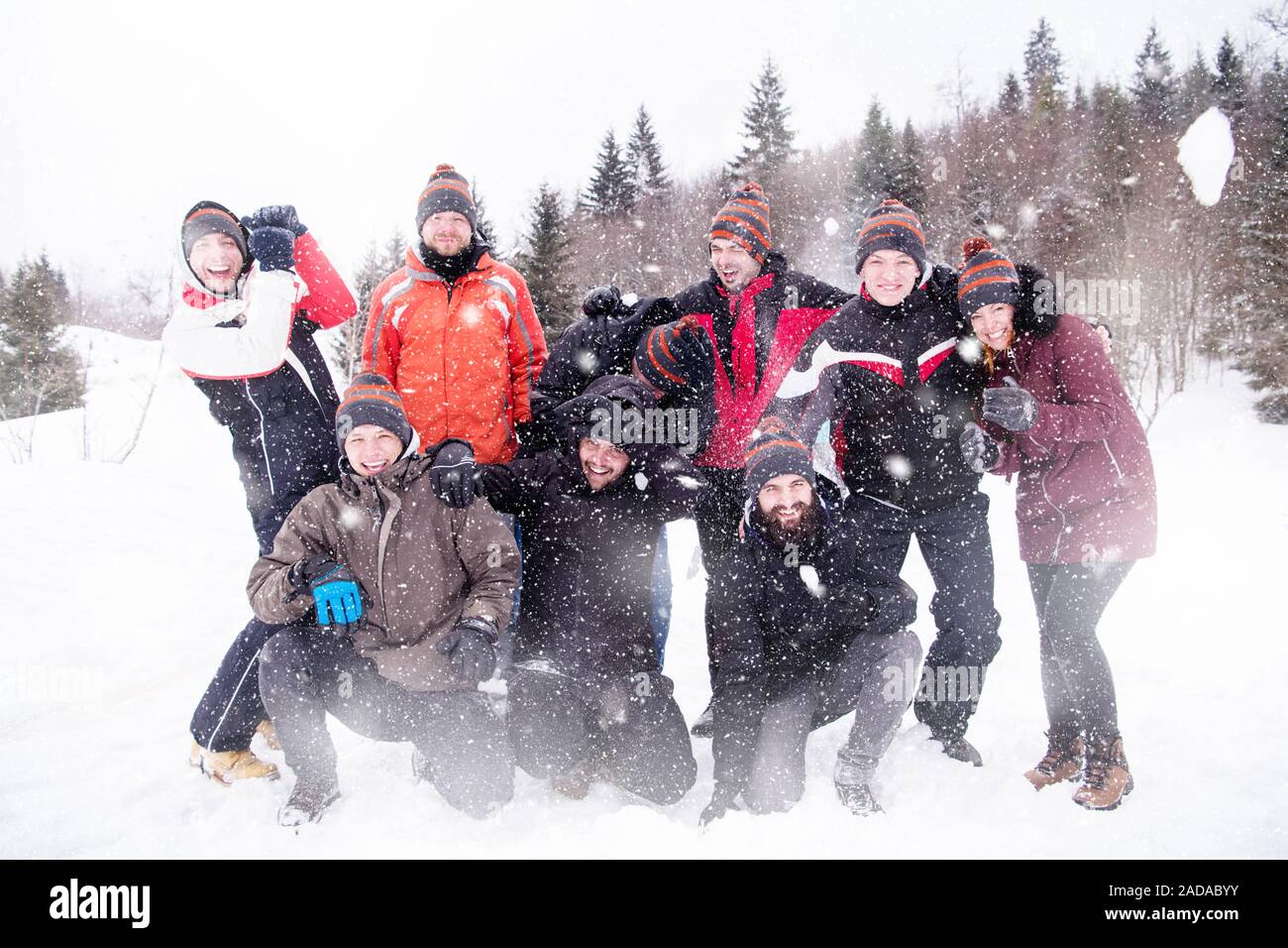 group of young people throwing snow in the air Stock Photo - Alamy