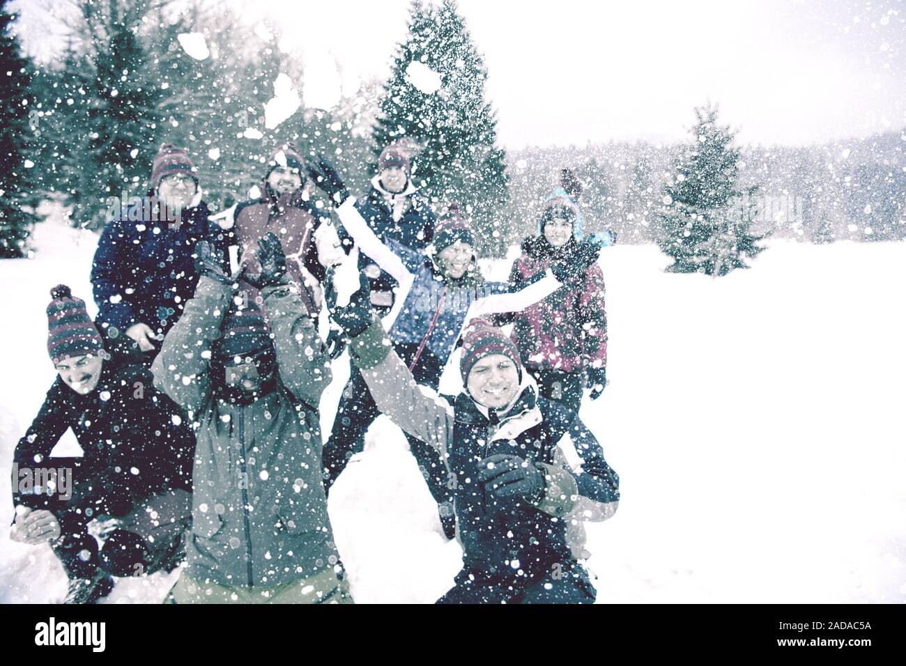 group of young people throwing snow in the air Stock Photo - Alamy
