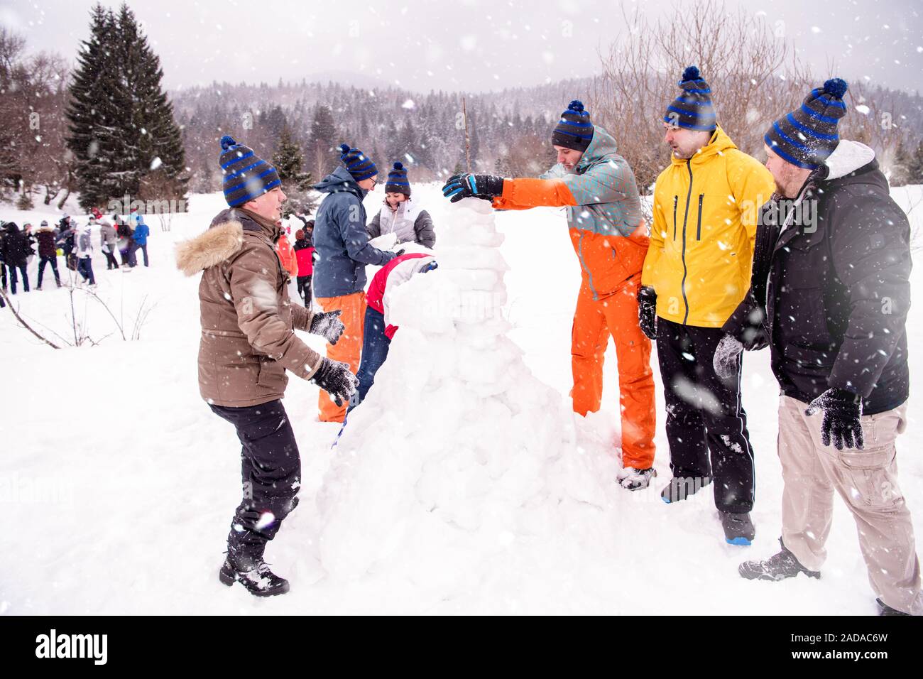Group young people building snowman hi-res stock photography and images ...