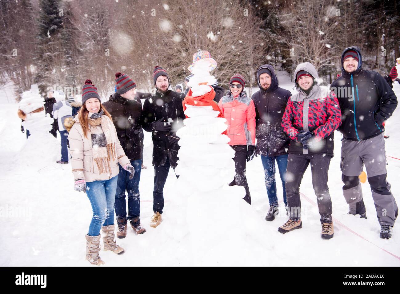 Group young people building snowman hi-res stock photography and images ...