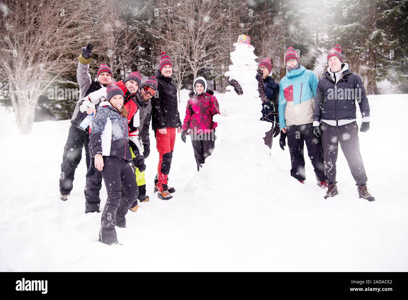 Group young people building snowman hi-res stock photography and images ...