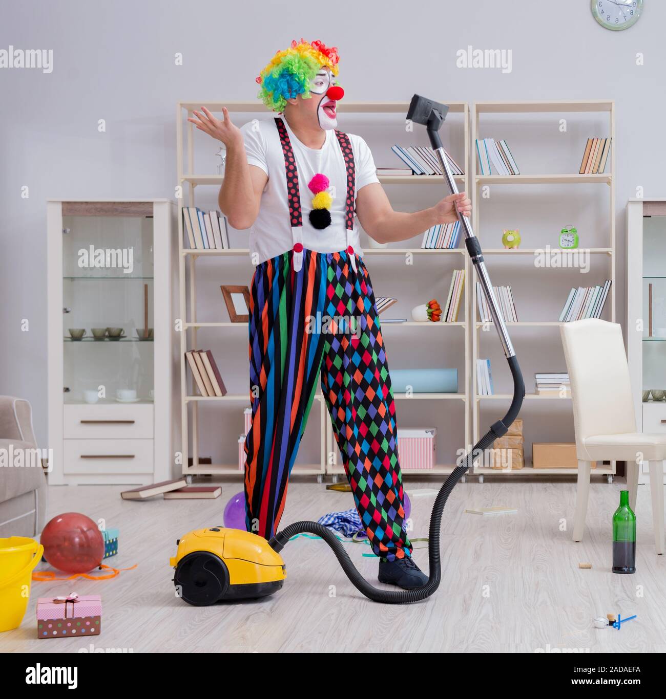 Funny clown doing cleaning at home Stock Photo - Alamy