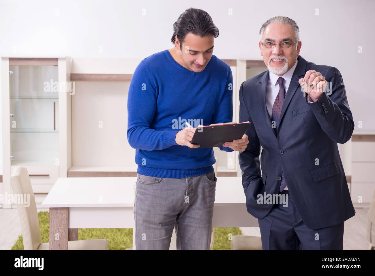 Male real estate agent and male client in the apartment Stock Photo - Alamy