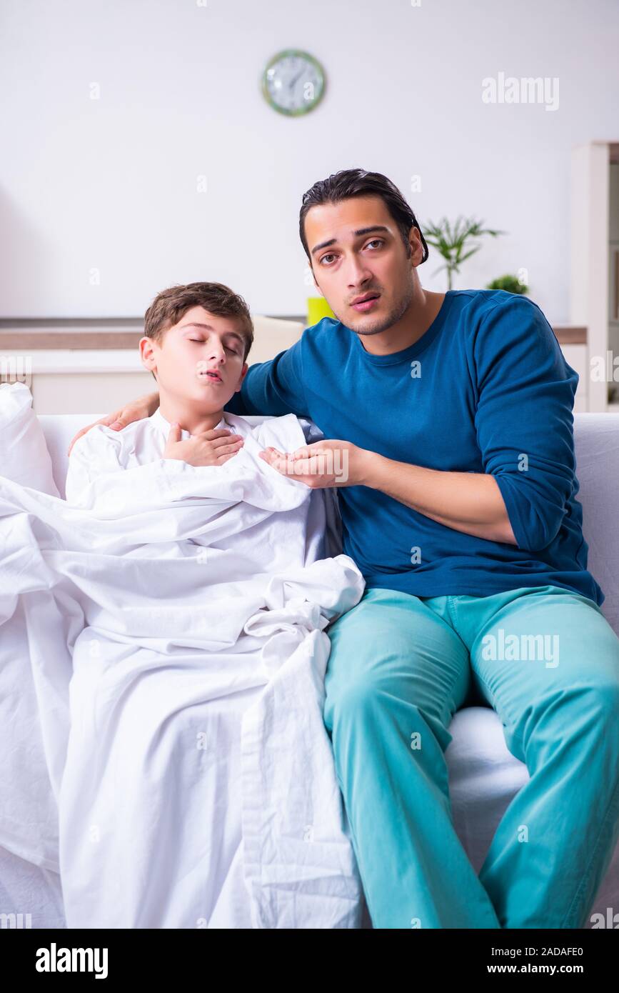 Young father caring for sick son Stock Photo - Alamy