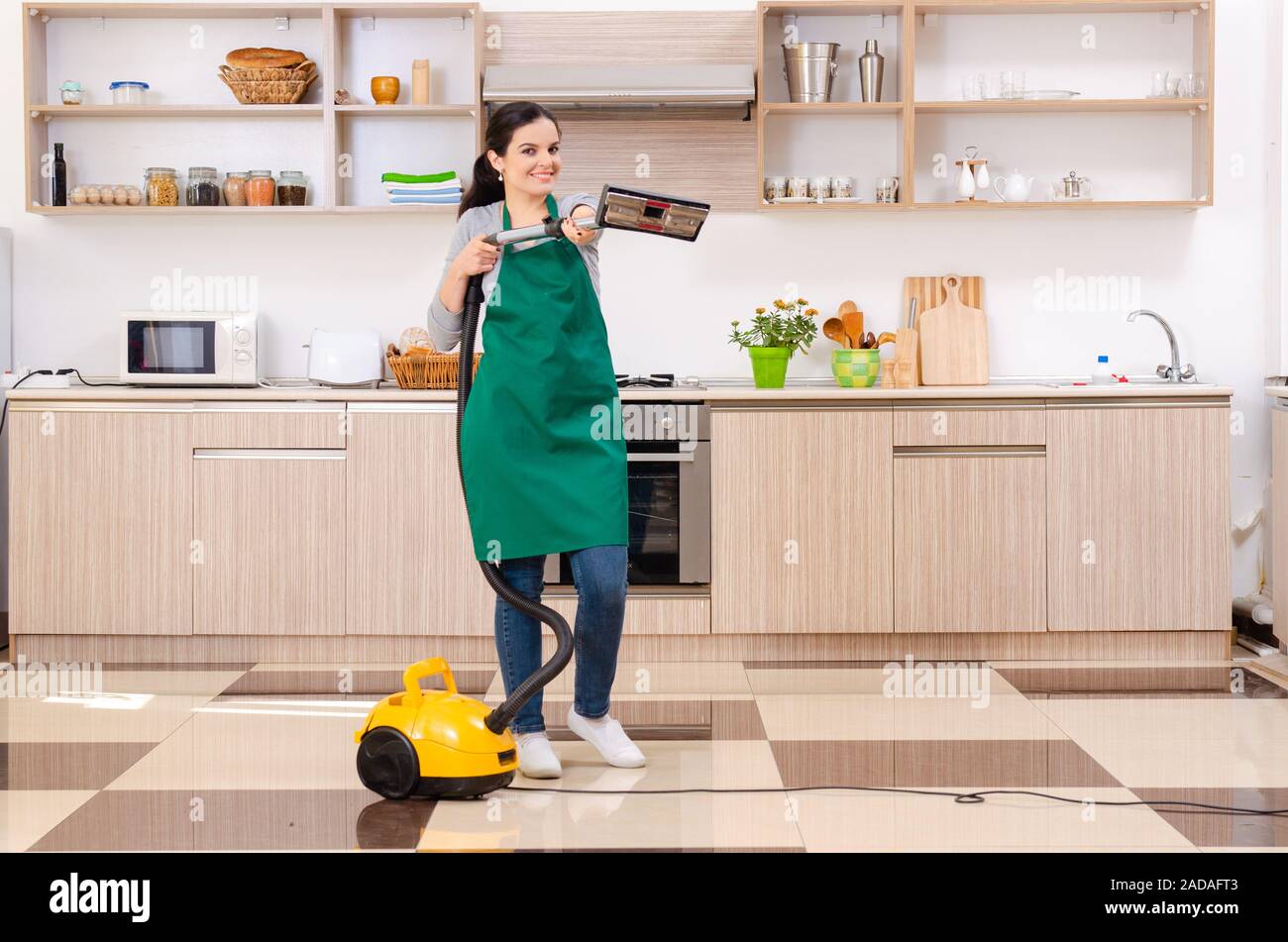 Young female contractor doing housework Stock Photo - Alamy