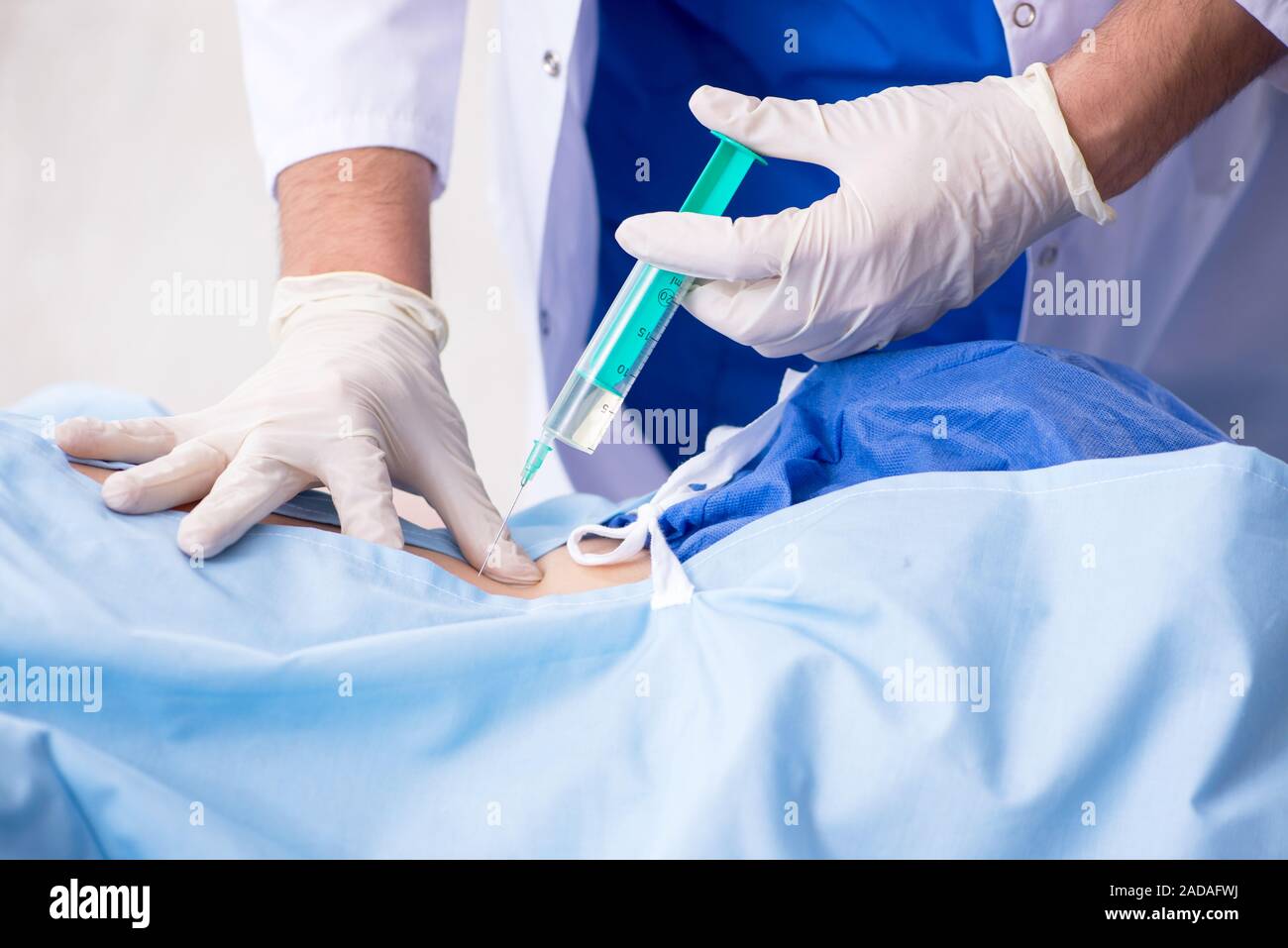 Female patient getting an injection in the clinic Stock Photo - Alamy