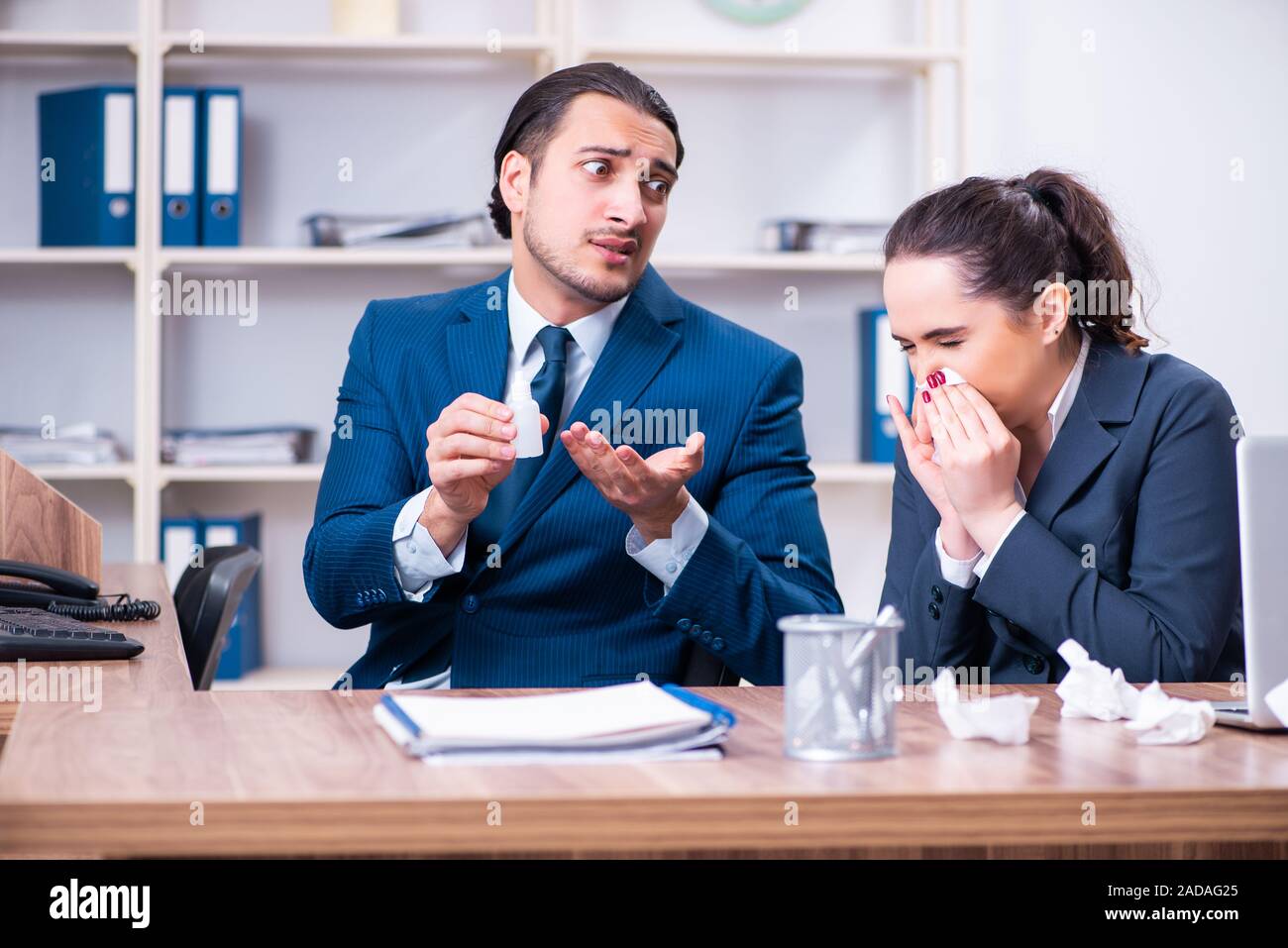 Two employees suffering at workplace Stock Photo - Alamy