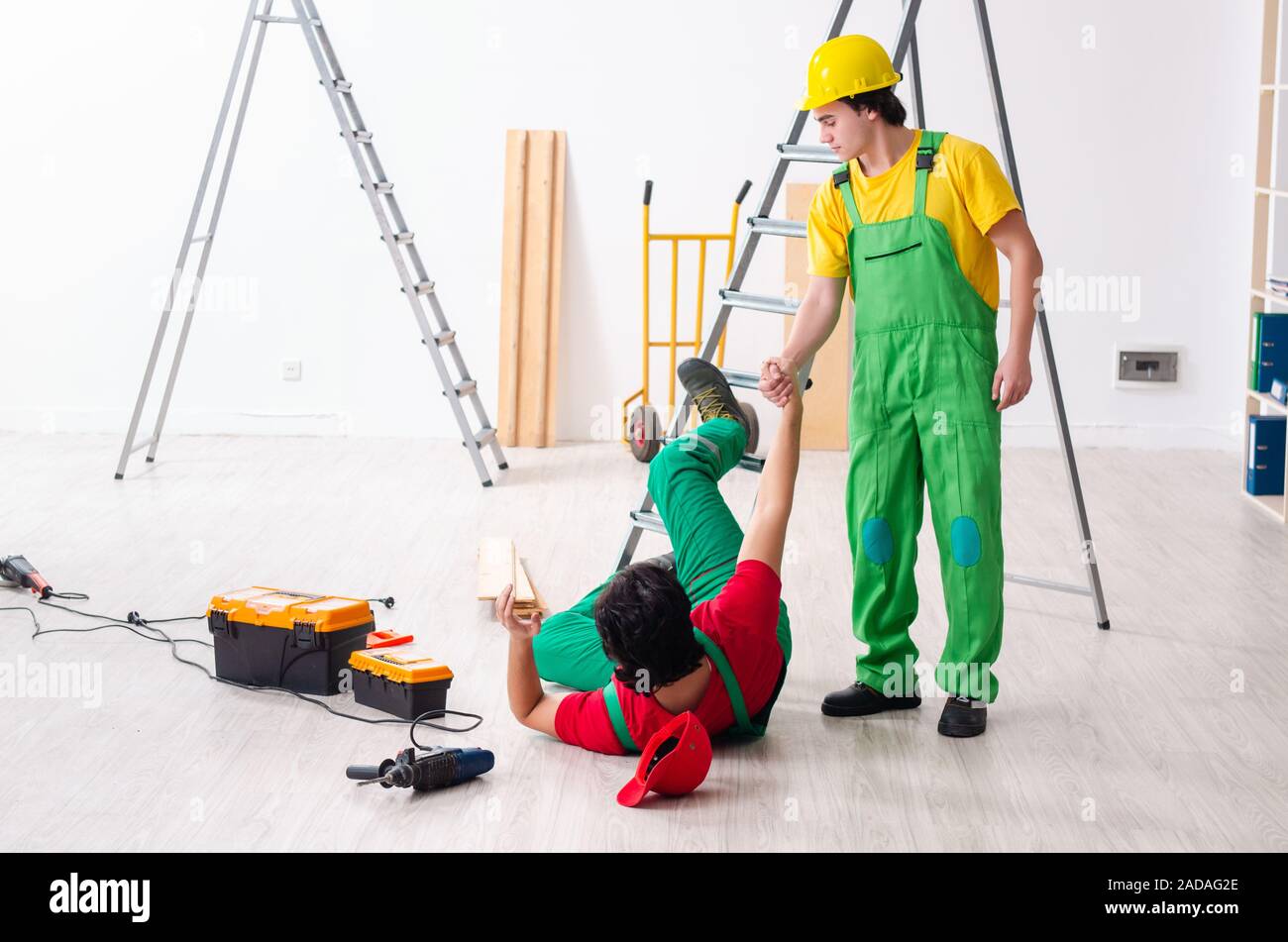 Injured worker and his workmate Stock Photo - Alamy