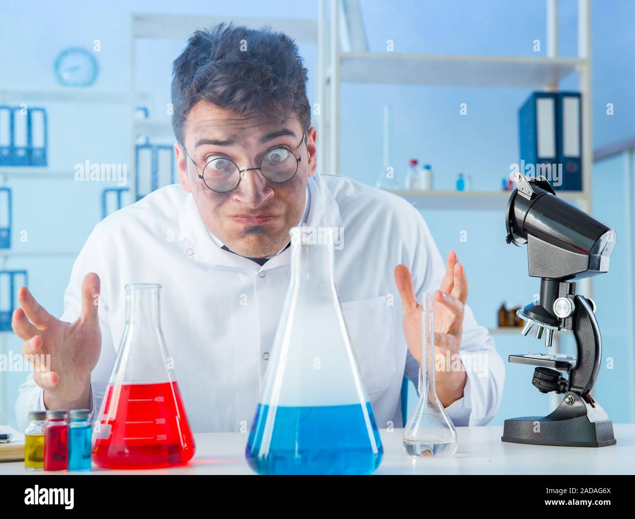 Funny mad chemist working in a laboratory Stock Photo - Alamy
