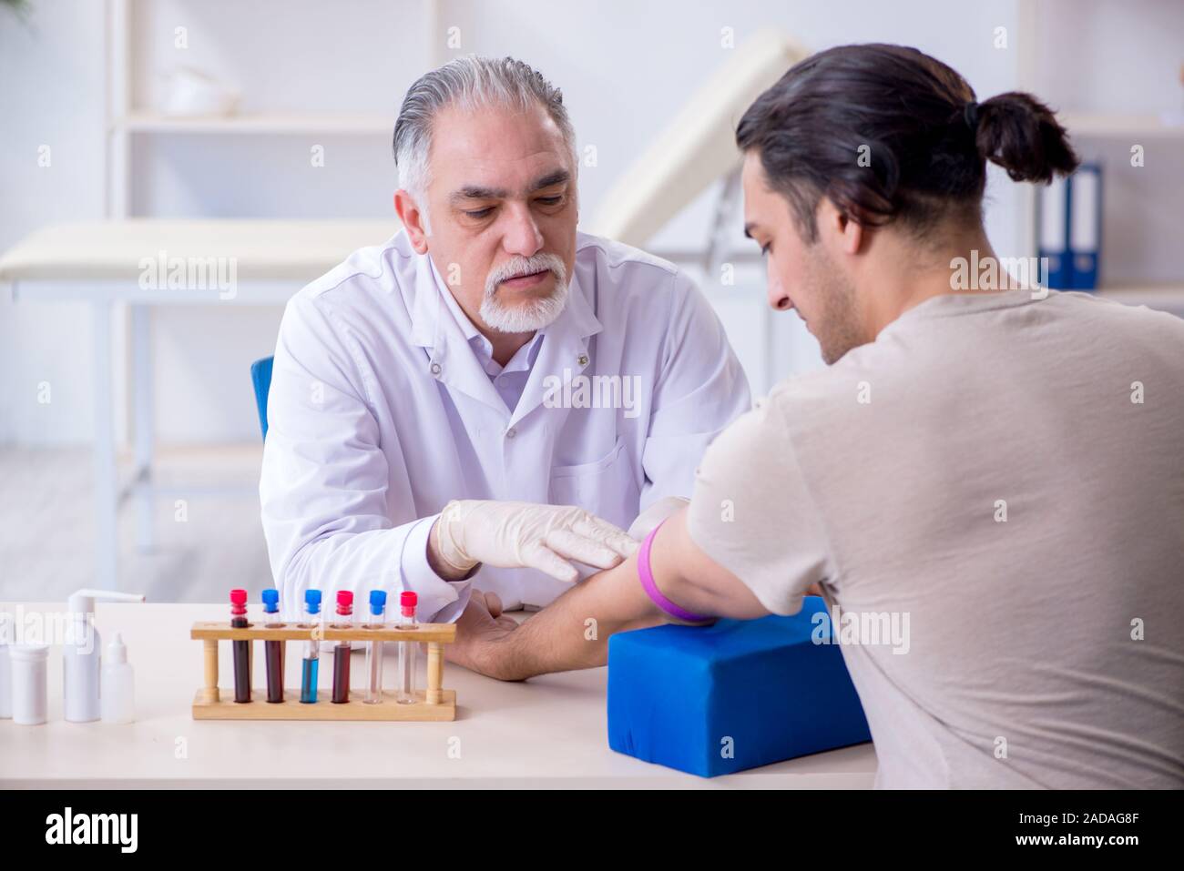 Young man doctor during medical procedure hi-res stock photography and ...