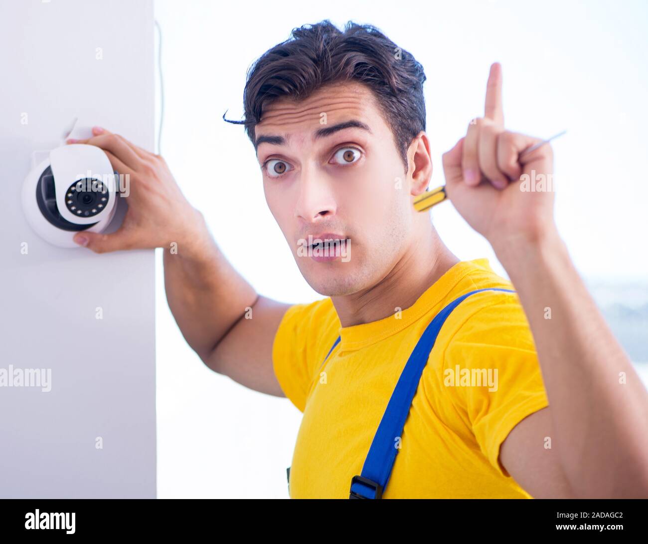 Contractor installing surveillance CCTV cameras in office Stock Photo ...