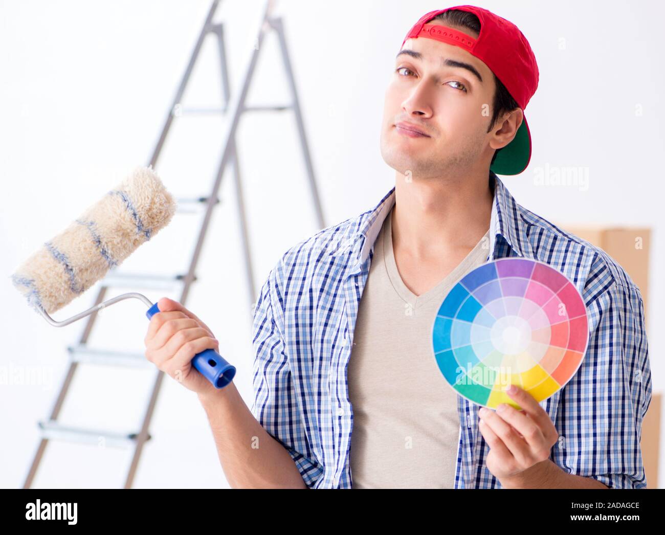 Young painter contractor choosing colors for home renovation Stock ...