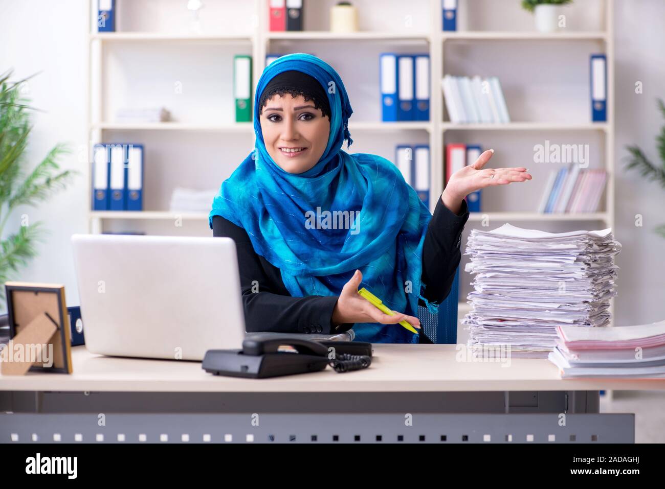 Female employee in hijab working in the office Stock Photo - Alamy