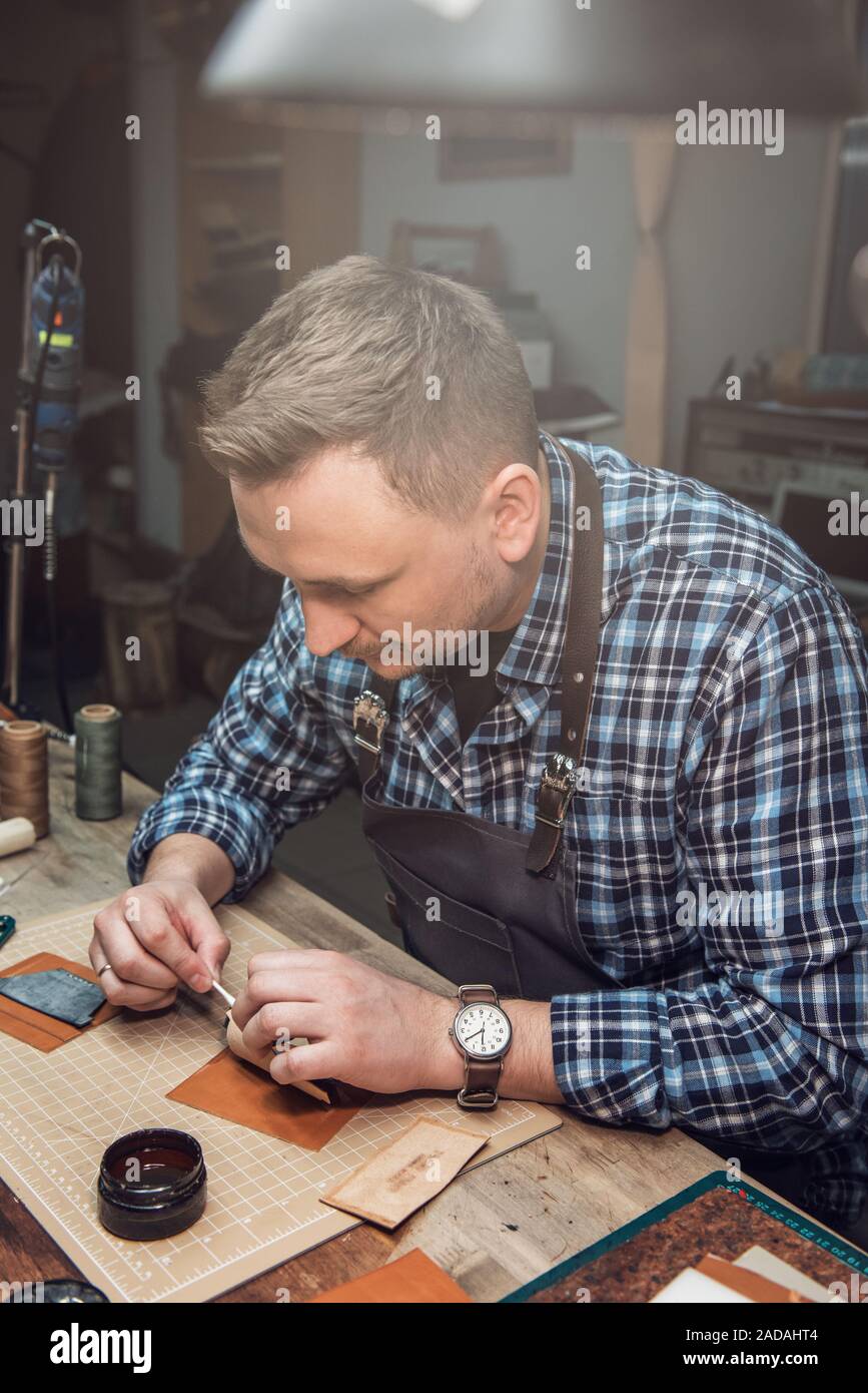 Concept of handmade craft production of leather goods Stock Photo - Alamy