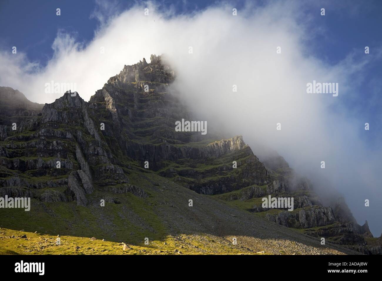 clouds in front of blue sky at the mountain Mosfell, East Iceland ...
