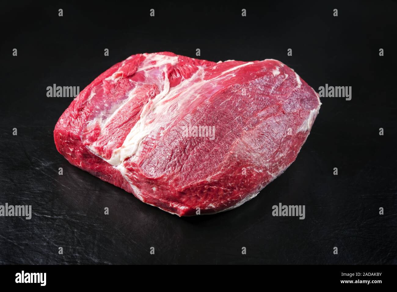 Raw dry aged wagyu silverside with eye of round piece as closeup on ...