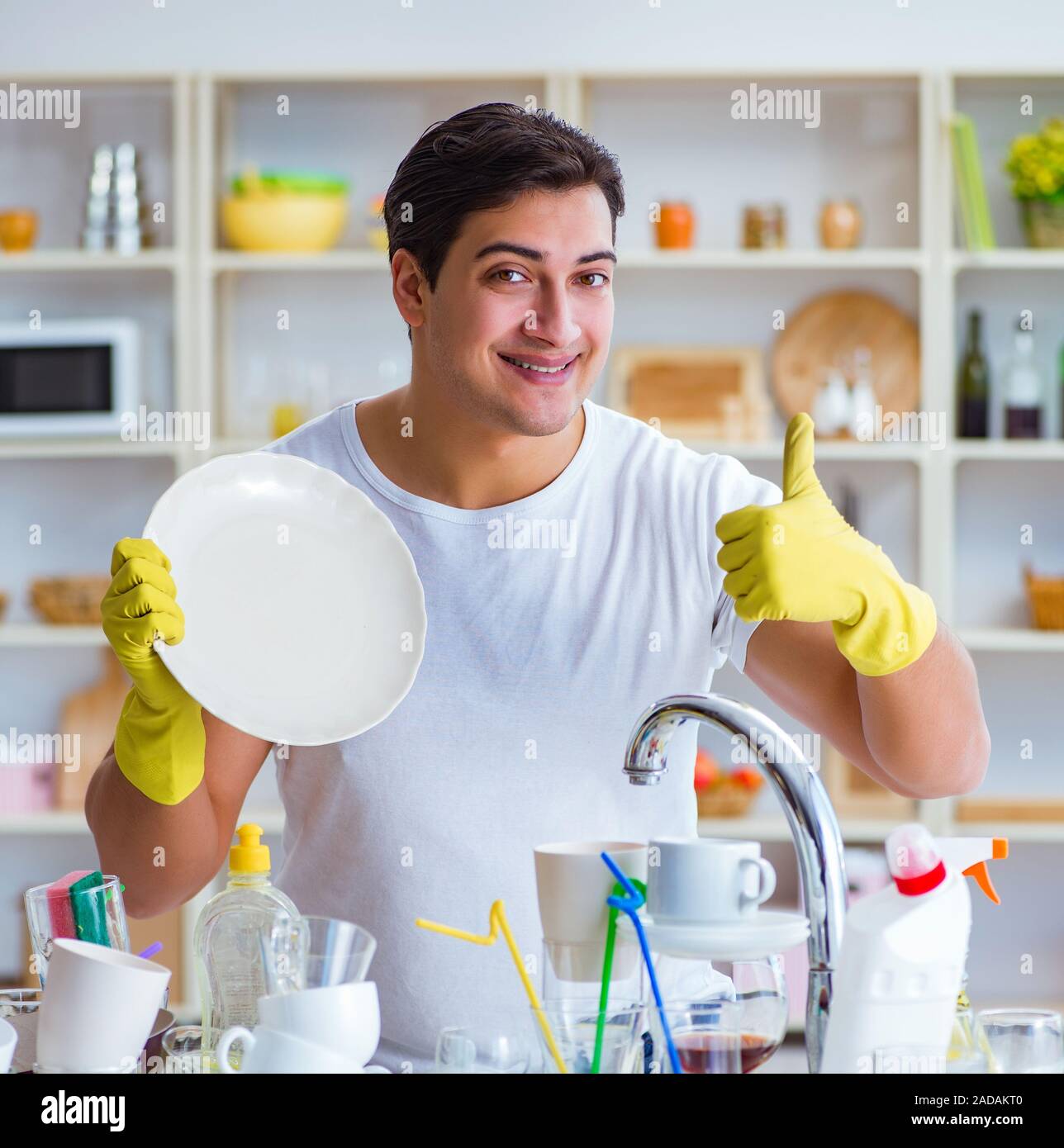 Man showing thumbs up washing dishes Stock Photo - Alamy